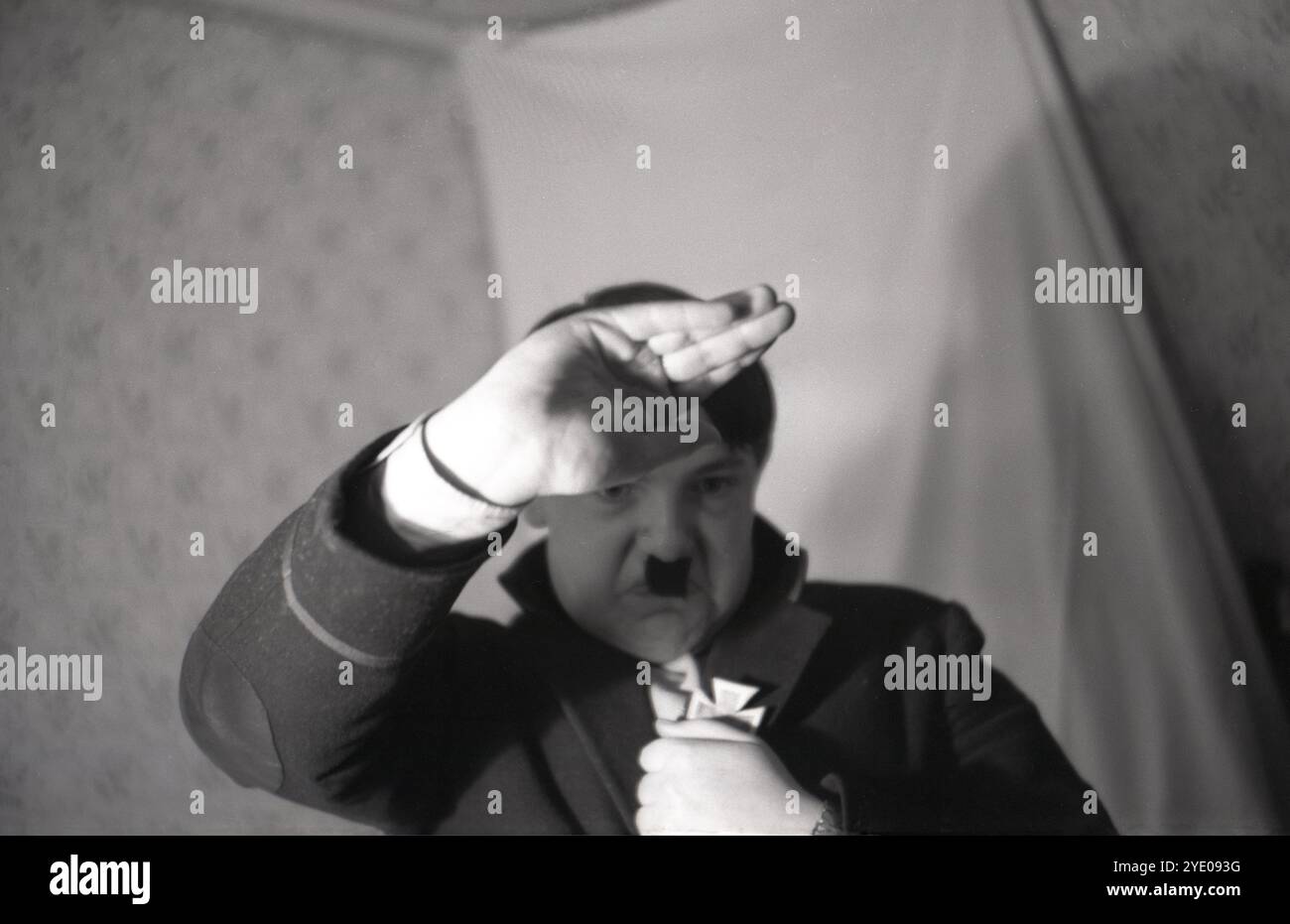 1950s, historical, an older teenage boy in his school jacket doing an ...