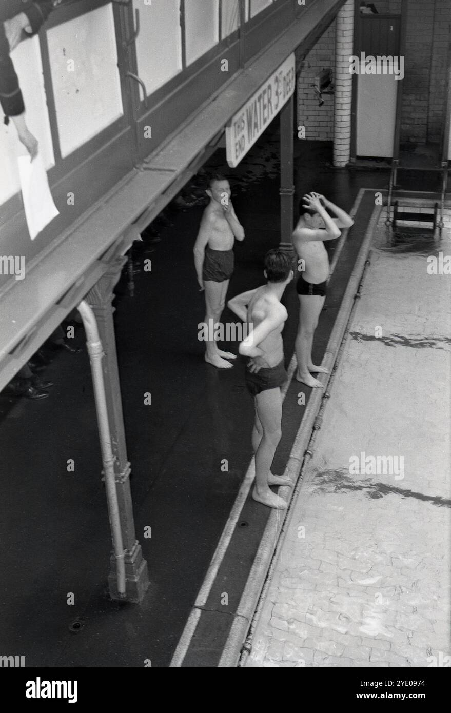 1950s, historical, swimming baths, overhead view of three schoolboys ...