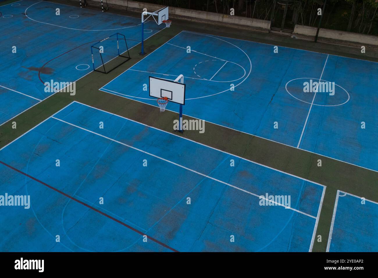Aerial view of blue basketball and sports courts in school playground ...