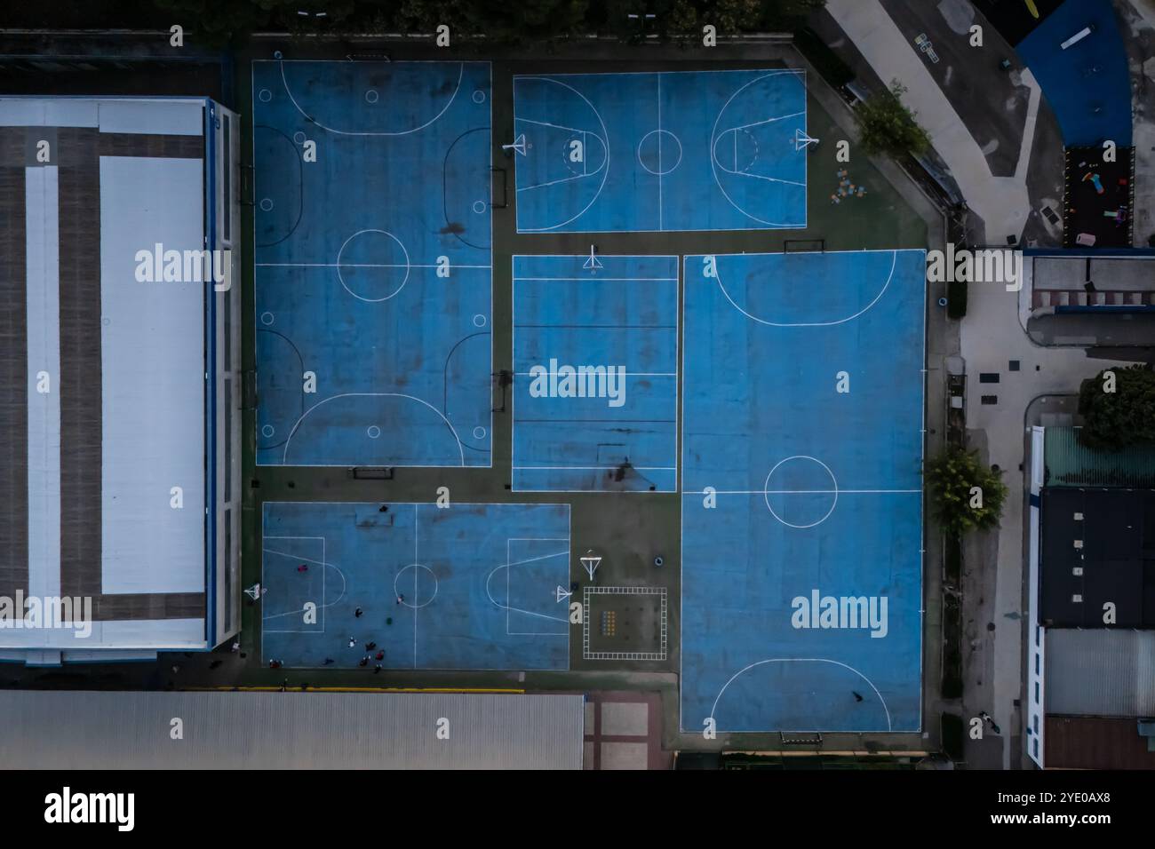 Aerial view of blue basketball and sports courts in school playground ...