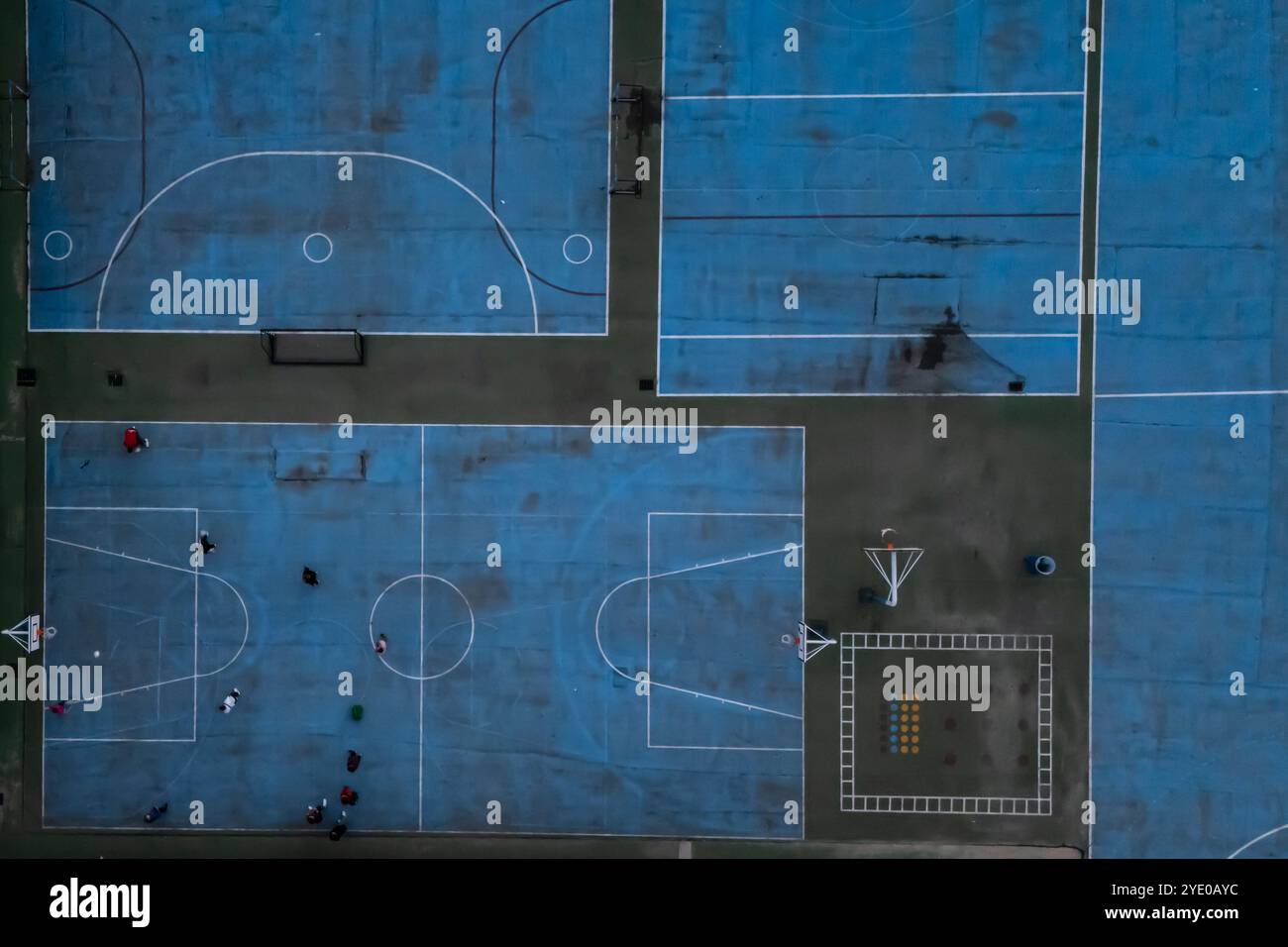 Aerial view of blue basketball and sports courts in school playground ...