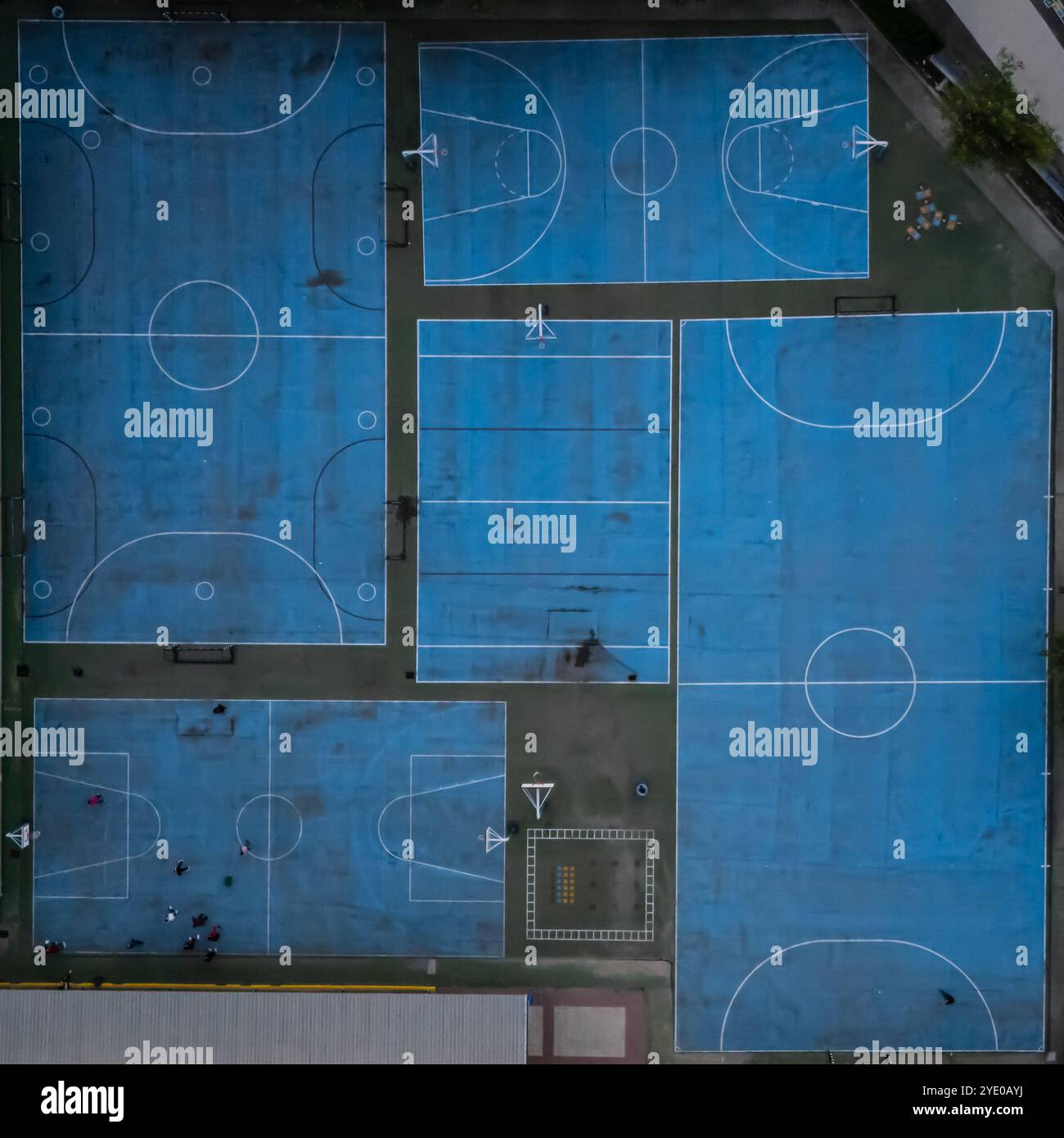 Aerial view of blue basketball and sports courts in school playground ...