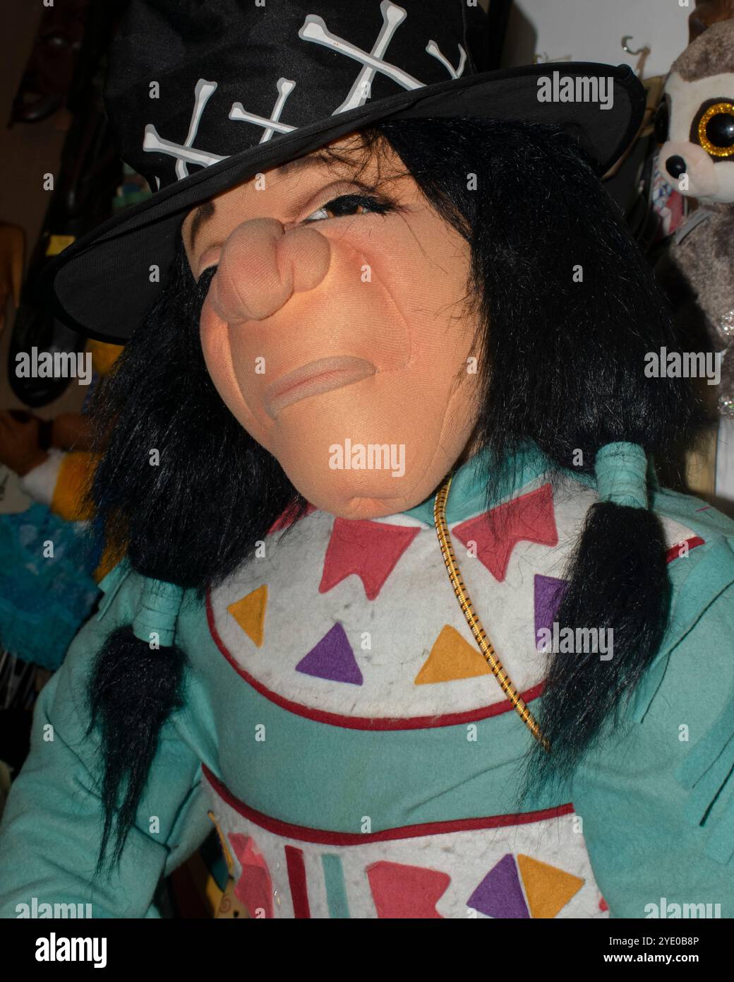 Creepy puppet or doll toy wearing black hat with crossed bones ...