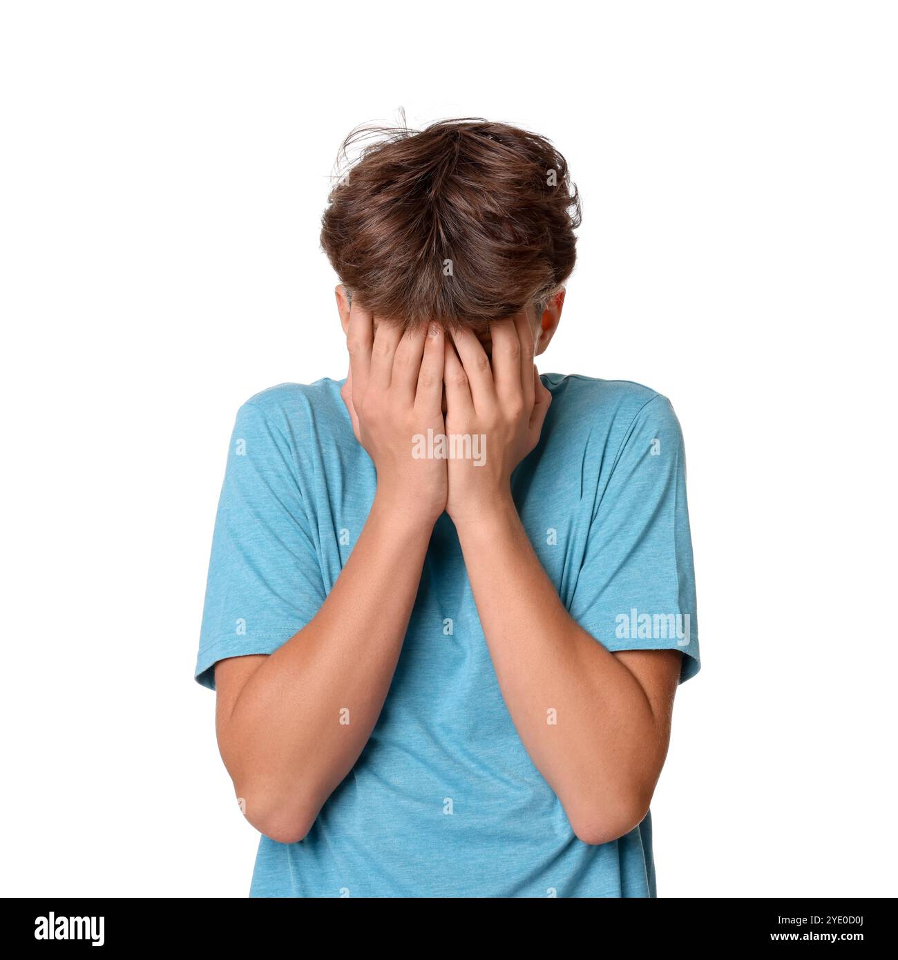 Scared teenage boy covering face with hands on white background Stock ...