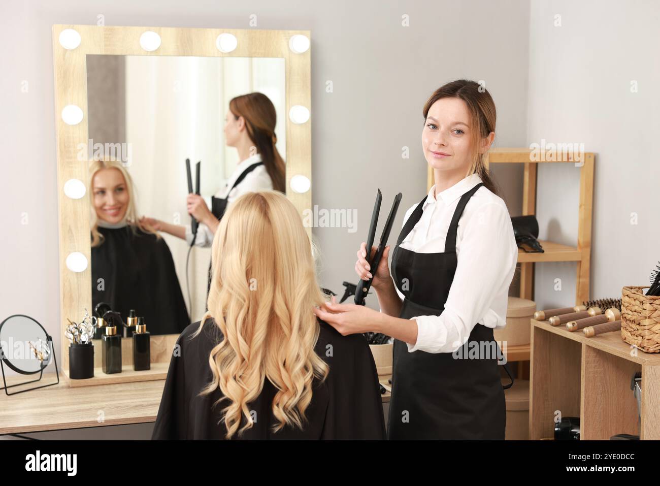 Hair cutting. Professional hairdresser working with client in salon ...