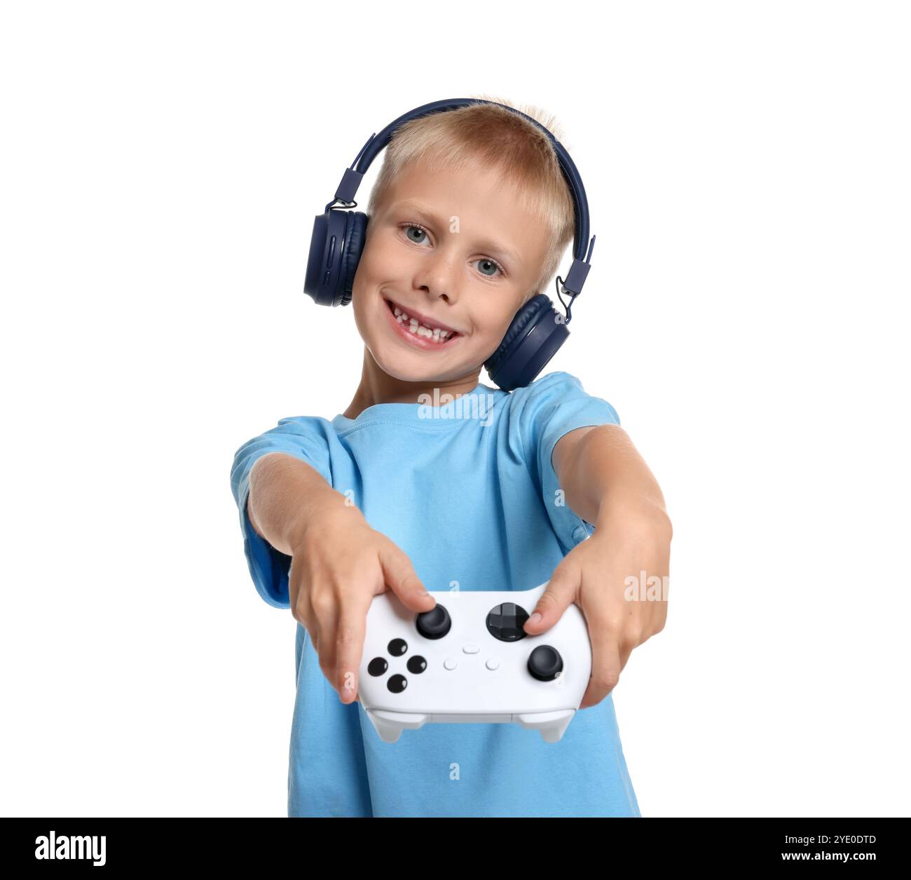 Happy little boy in headphones playing video game with controller on ...
