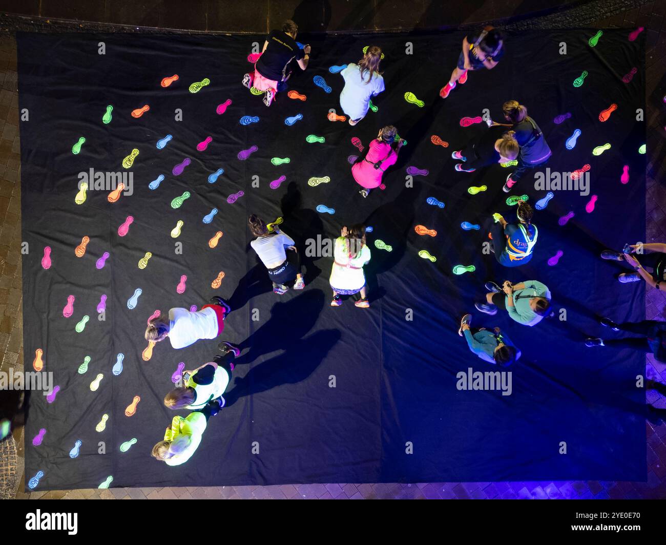 EDITORIAL USE ONLY An aerial view of a display of UV-lit footsteps as ...