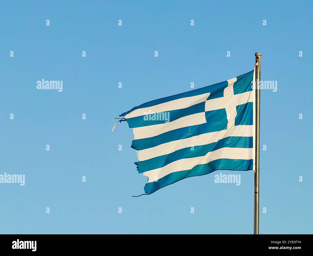 Greek Flag Waving on Metal Post Against Clear Blue Sky Stock Photo - Alamy