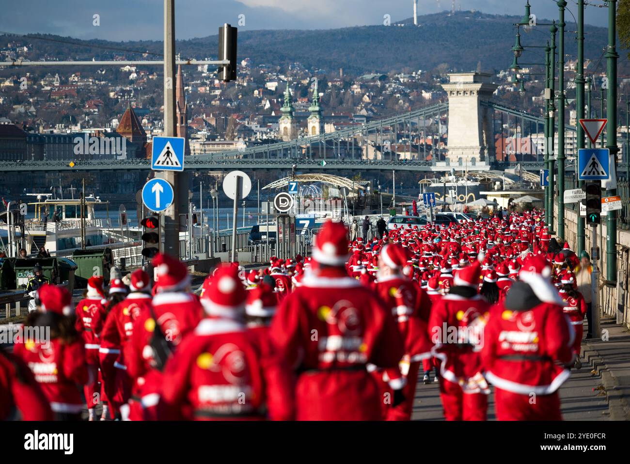 Crowd of people in Santa Claus uniform running along the road Stock ...