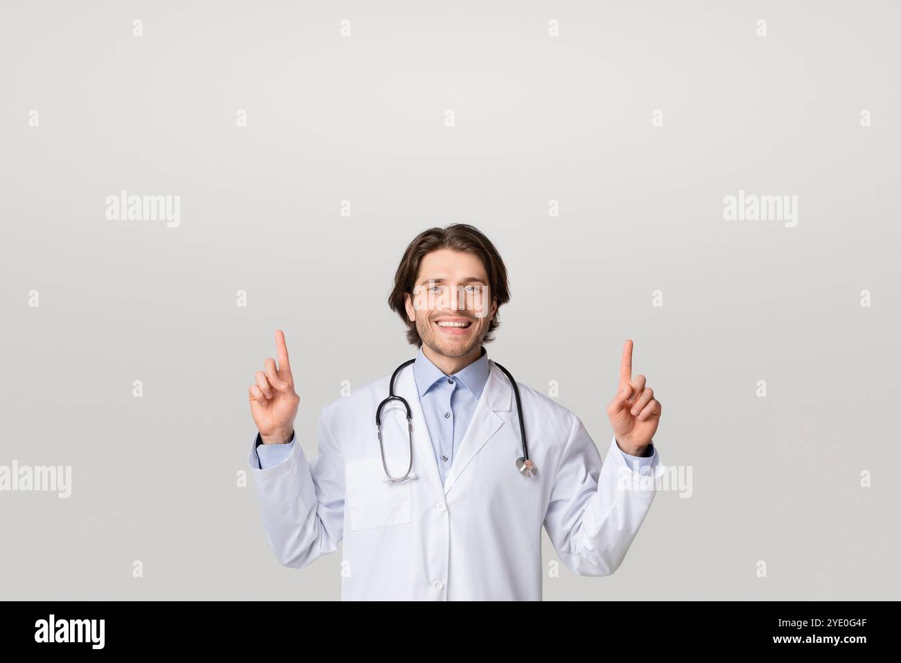 Young adult pointing above head hi-res stock photography and images - Alamy
