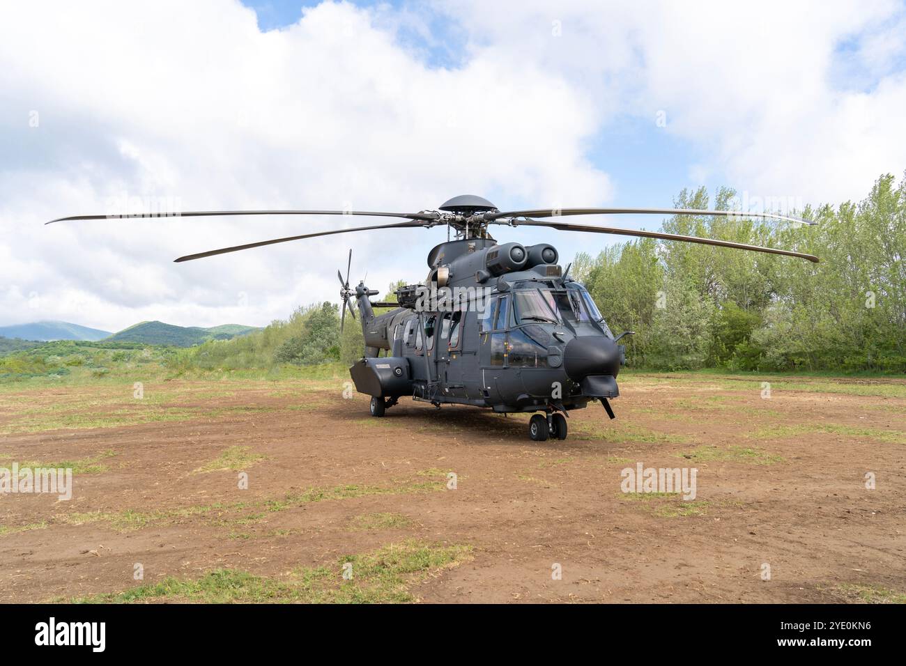 Black painted modern H225 military transport helicopter stationary on ...