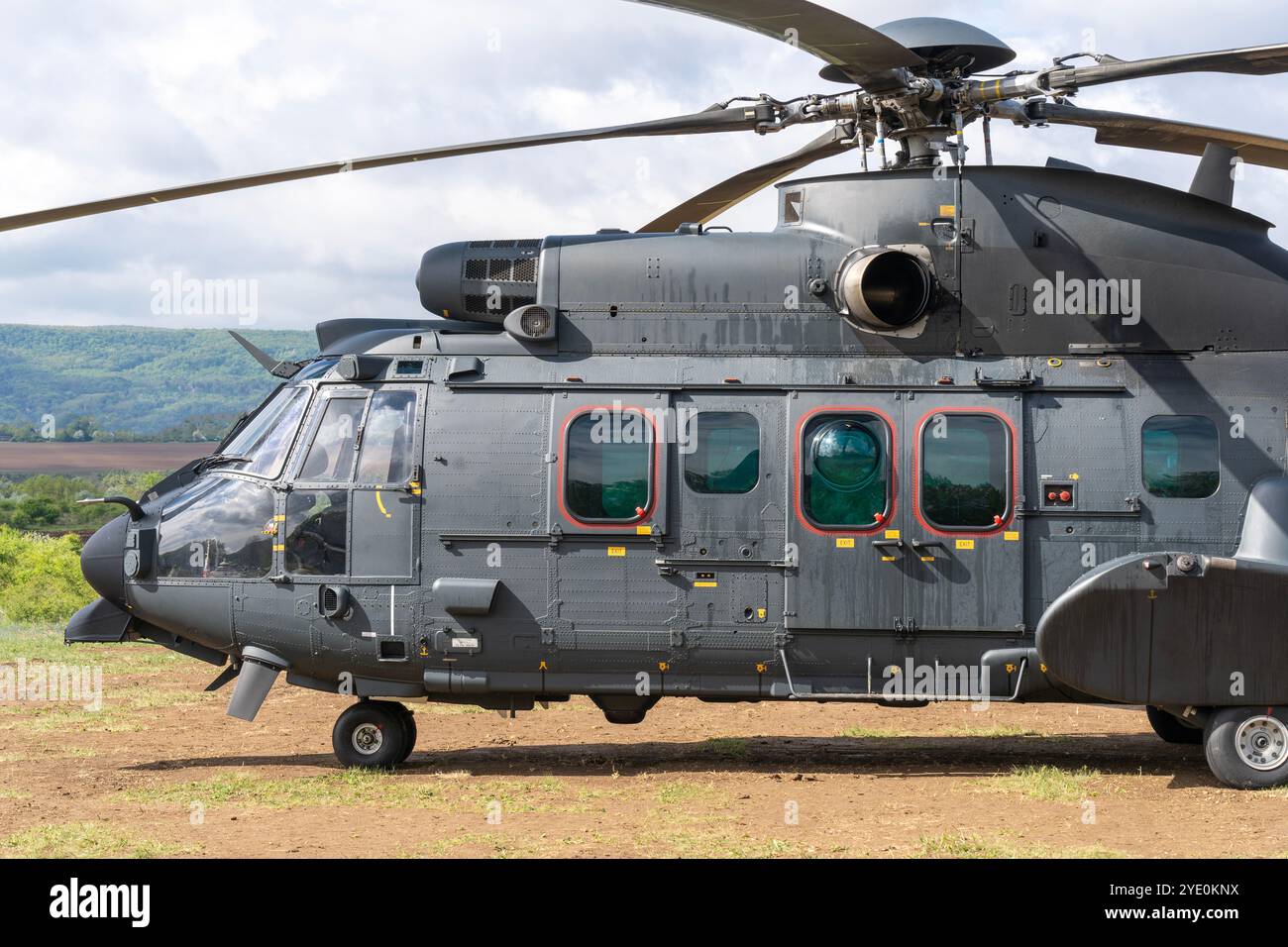 Black painted modern H225 military transport helicopter stationary on ...