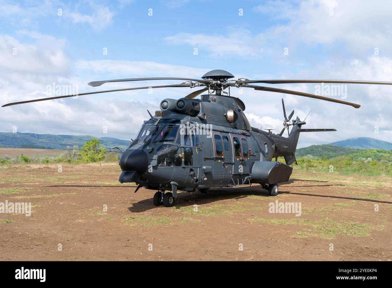 Black painted modern H225 military transport helicopter stationary on ...