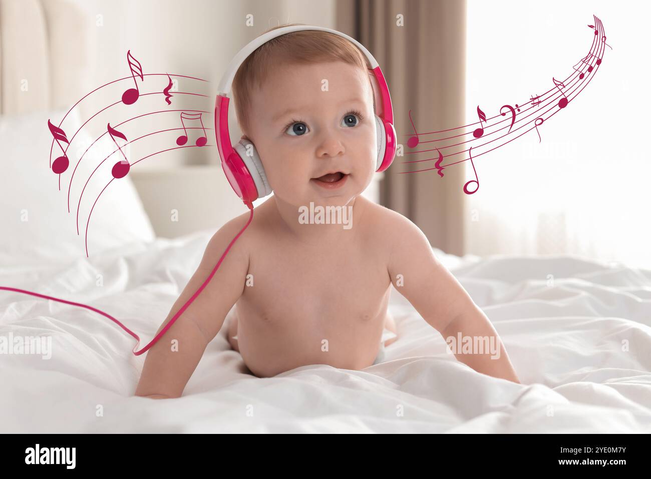 Cute little baby with headphones on bed at home. Music notes flying ...