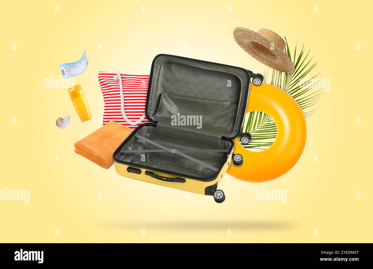 Empty suitcase, green leaf, ticket and beach stuff in air on yellow ...