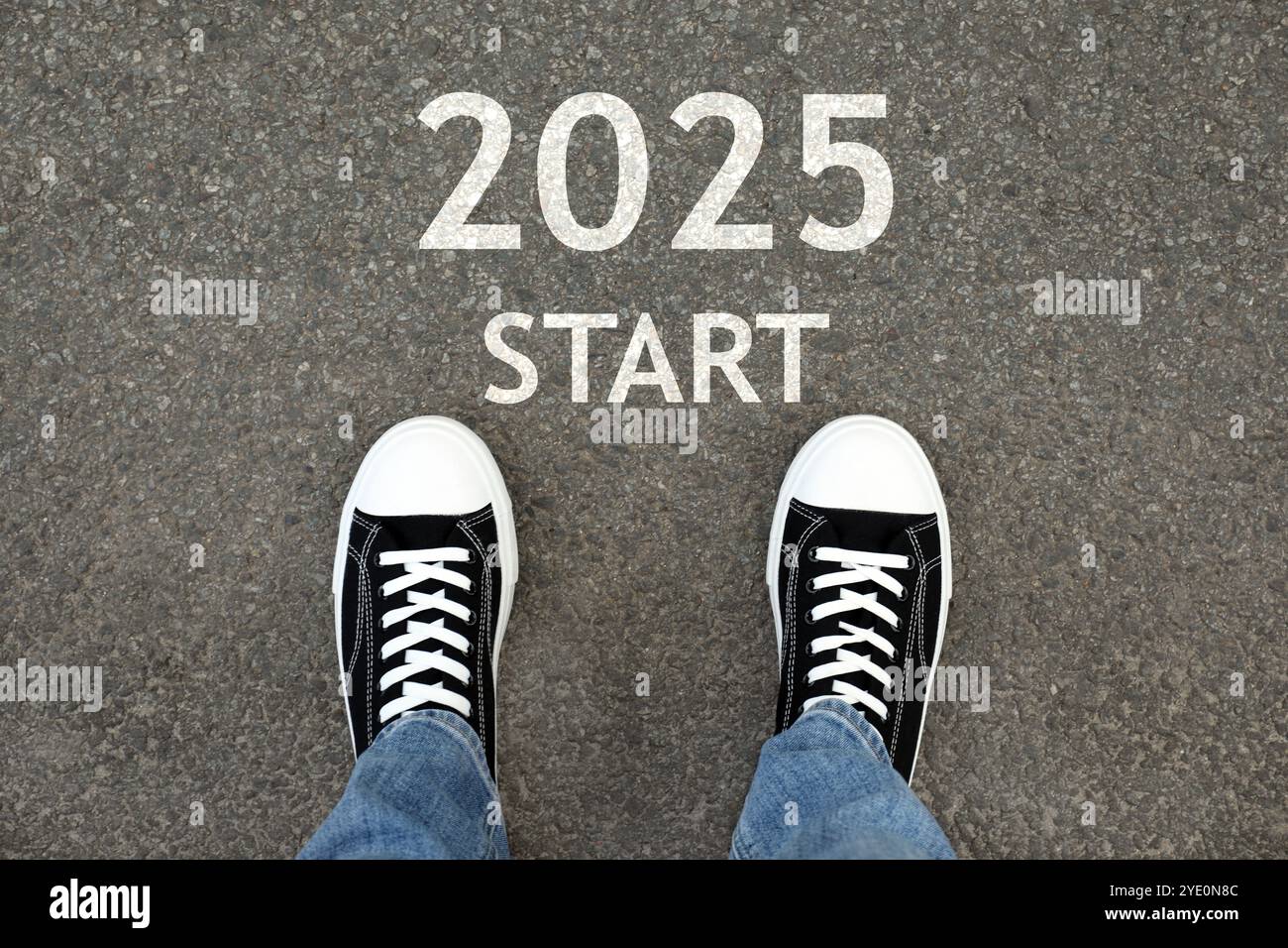 Man standing near sign 2025 Start on asphalt, top view. Concept of new year, fresh beginning ...