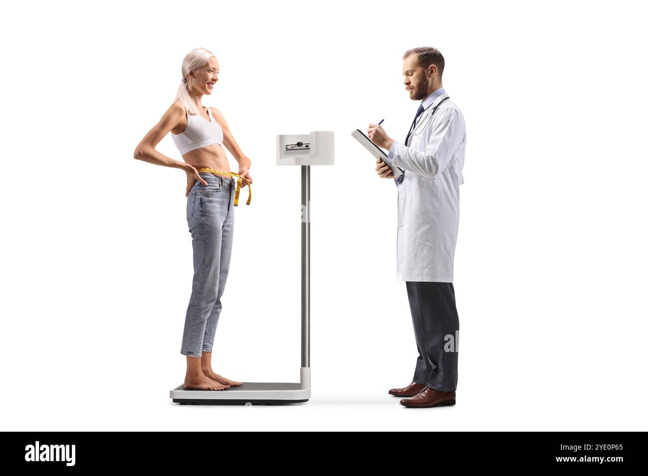 Doctor measuring a female patient on a weight scale isolated on white ...
