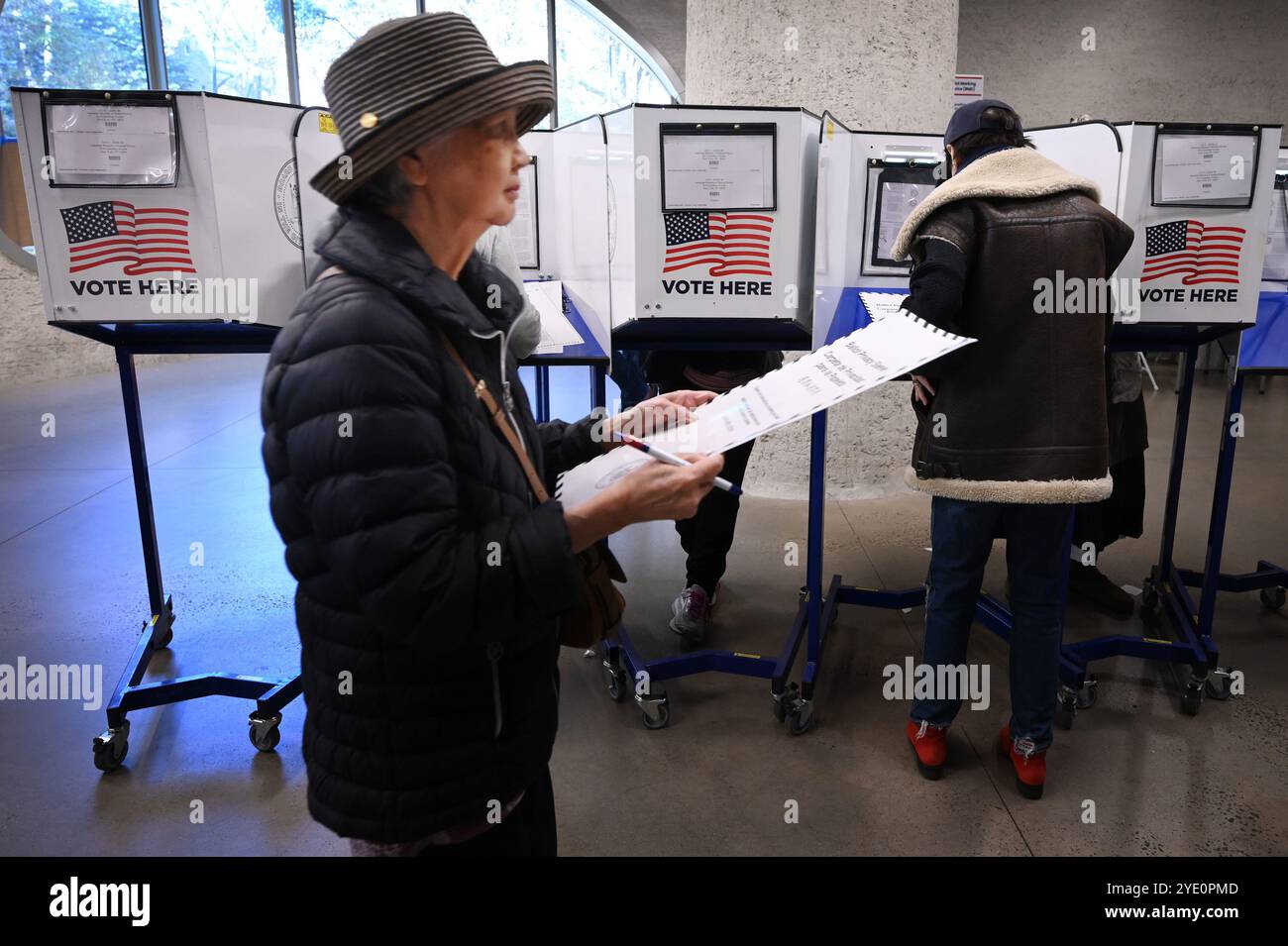 Voters fill in ballots at a voting site set up inside the American ...