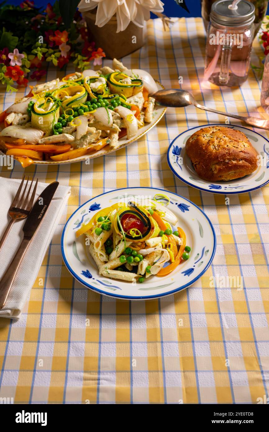 Vegetarian Penne pasta with grilled vegetables and table setting Stock ...