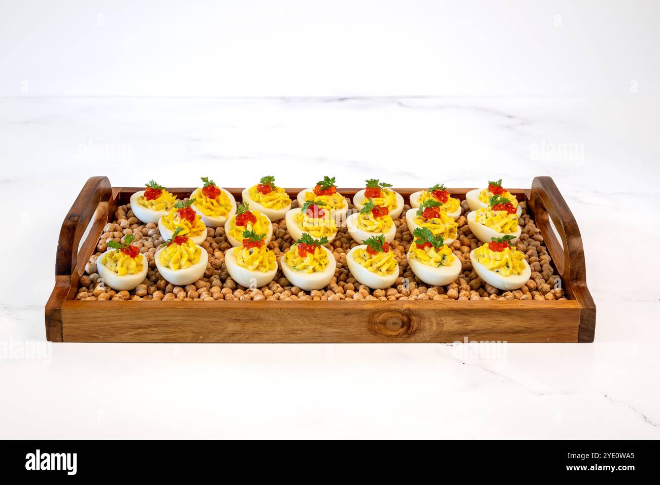 Wooden platter of devilled eggs with roe and parsley Stock Photo - Alamy