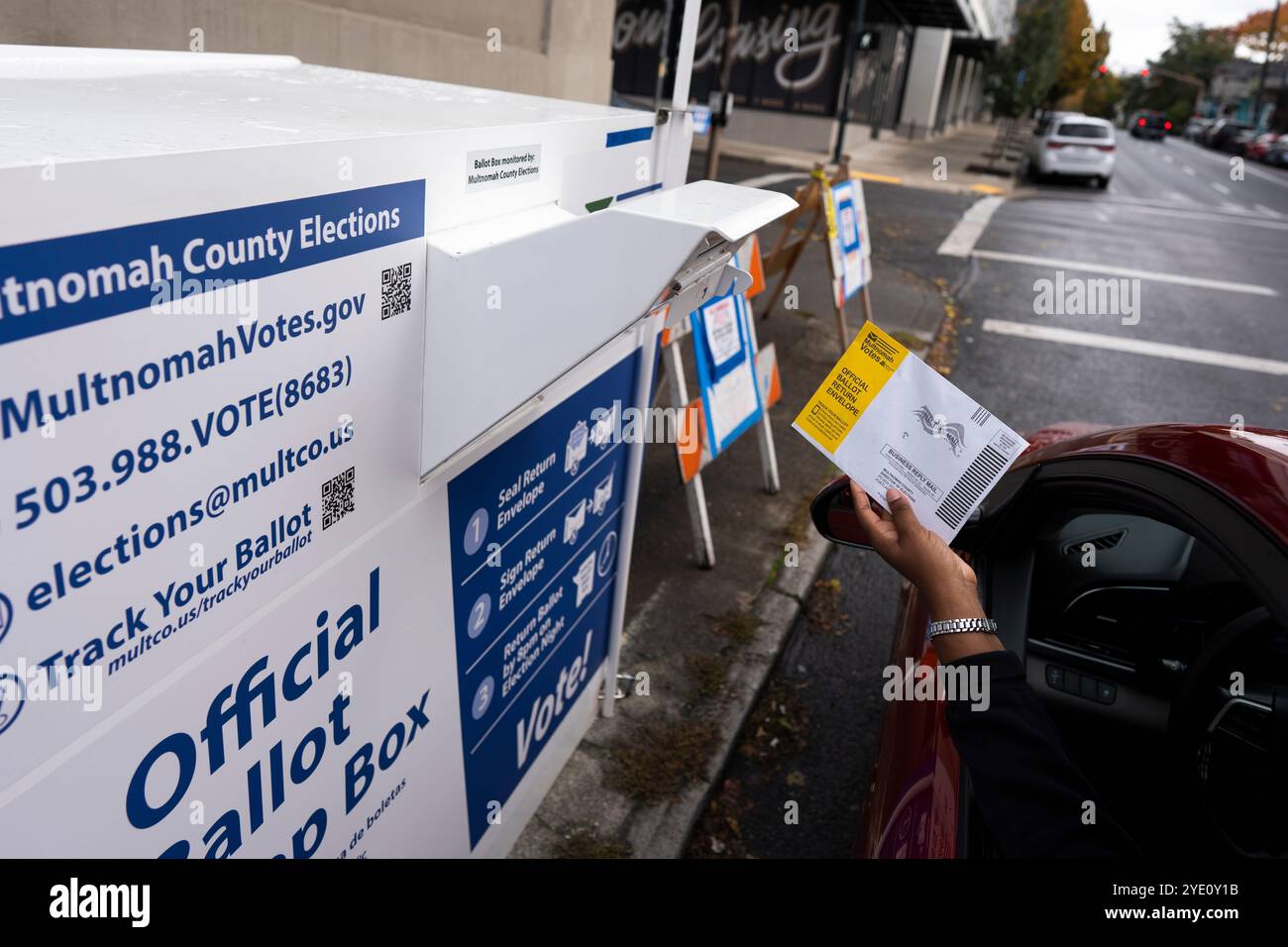 A voter drops off a ballot for the 2024 election in a newly installed ...