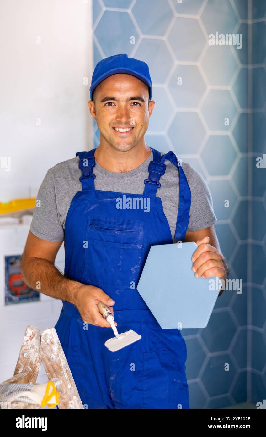 Portrait of positive man tiler Stock Photo - Alamy