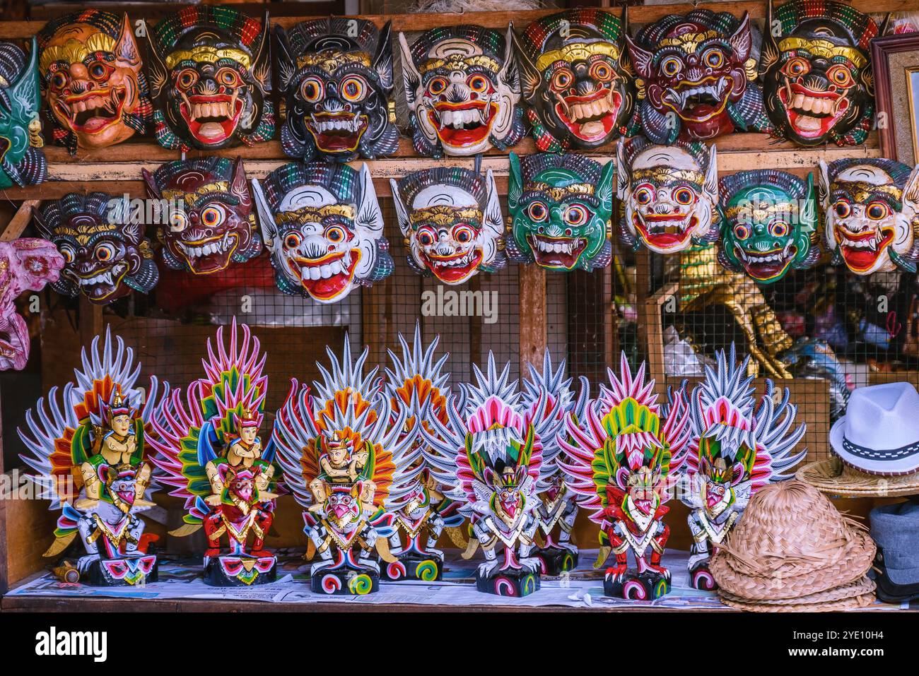 Traditional balinese wooden masks and statues displayed in a souvenir ...
