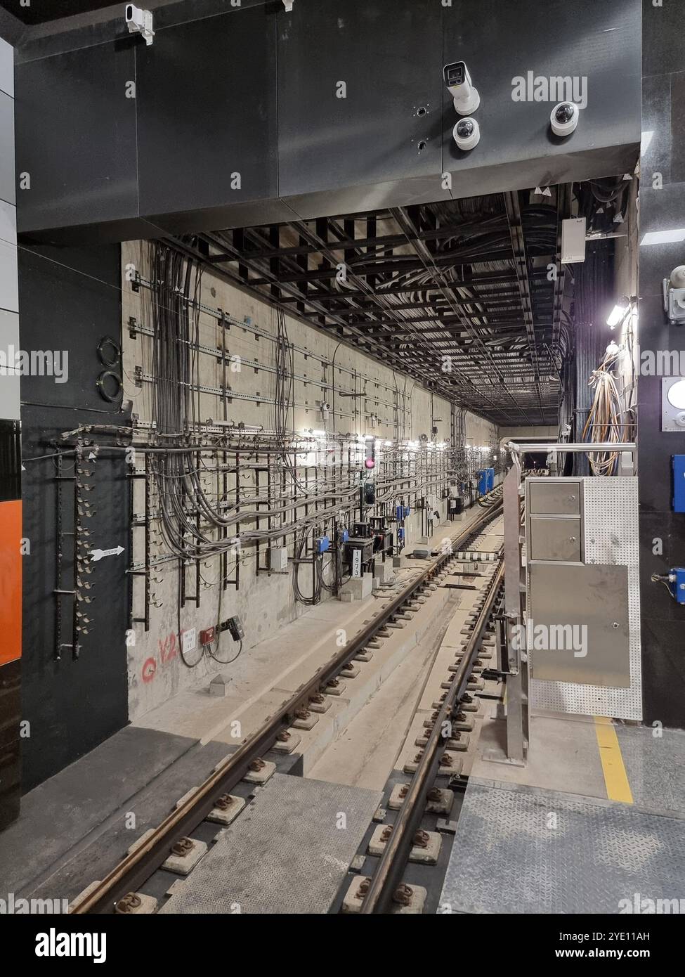 View into metro tunnel with cables, tubes at subway station ...