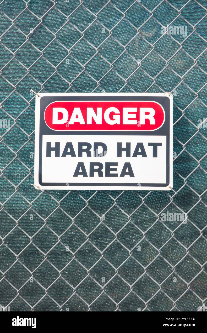 Sign danger hard hat area on a chain link fence Stock Photo - Alamy