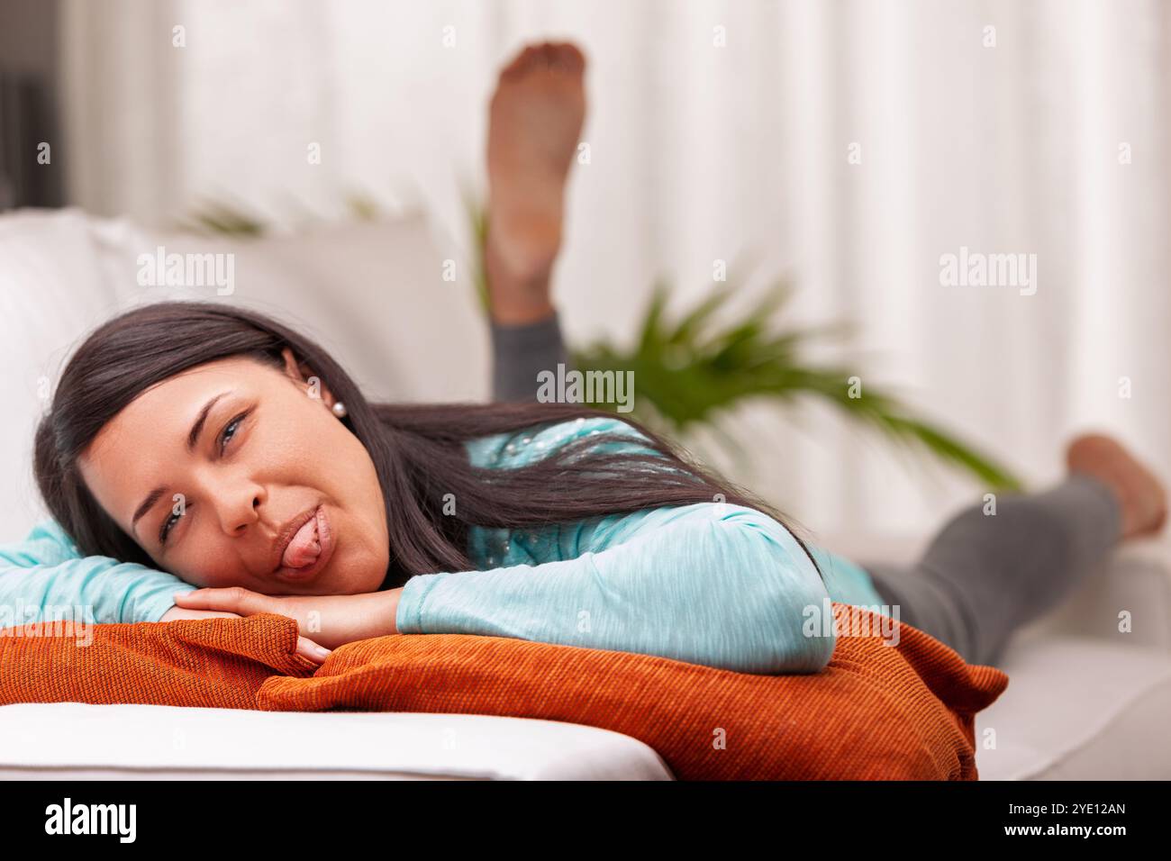 Woman playfully sticking tongue hi-res stock photography and images - Alamy