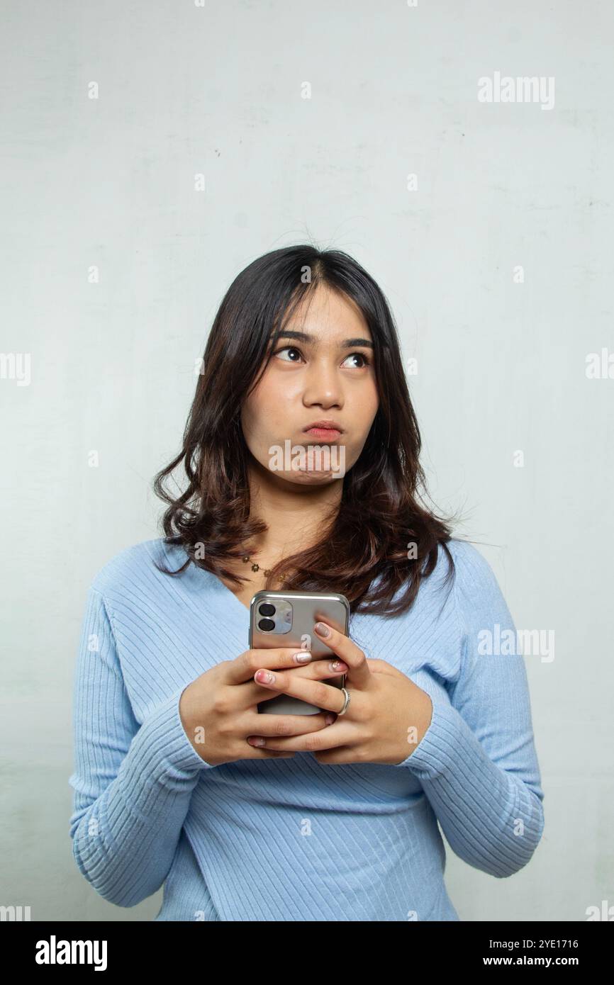 isolated portrait of teenage woman standing with disappointed face with ...