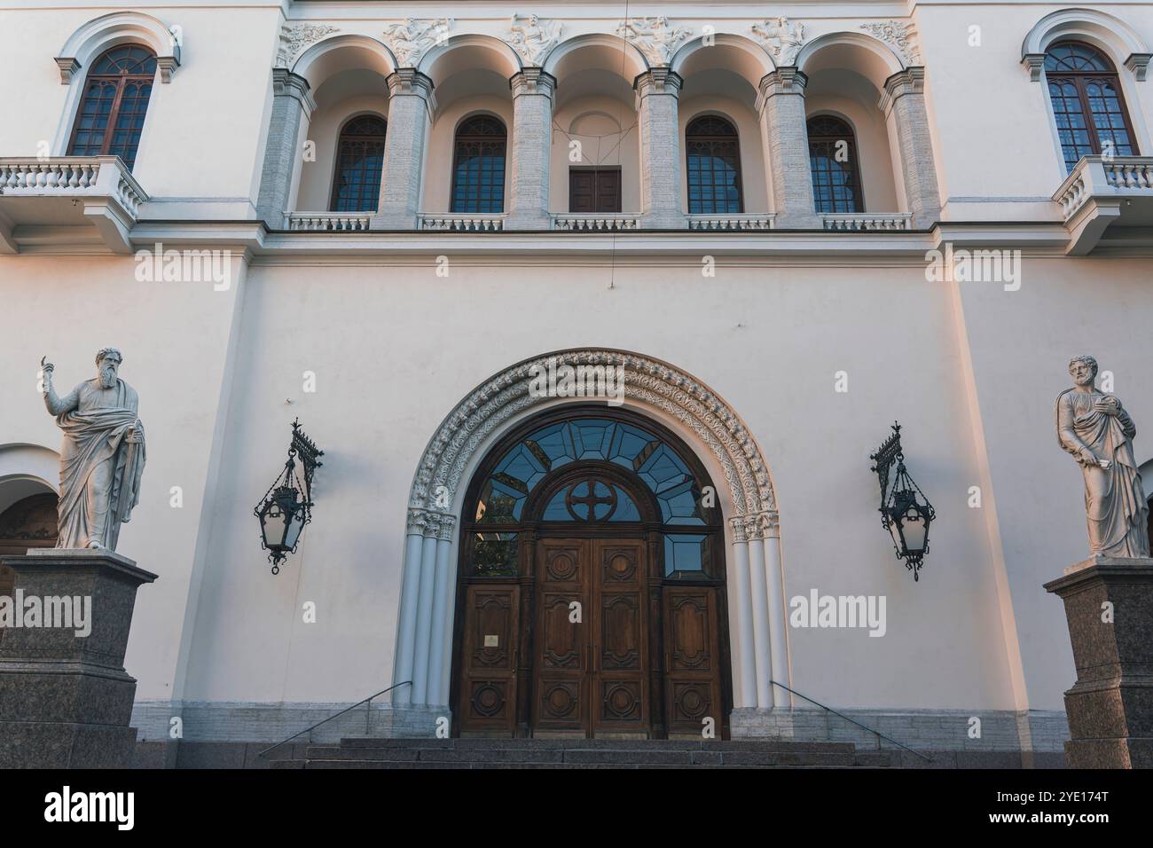 Close-up of an ornate entrance featuring statues and an arched doorway ...