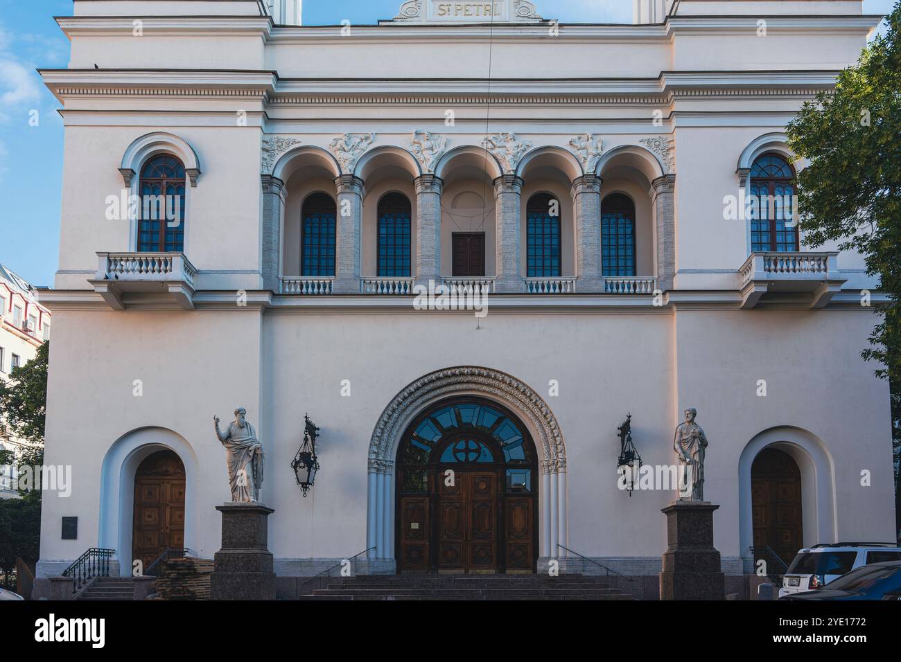 View of a historic church through an ornate entrance gate, featuring ...