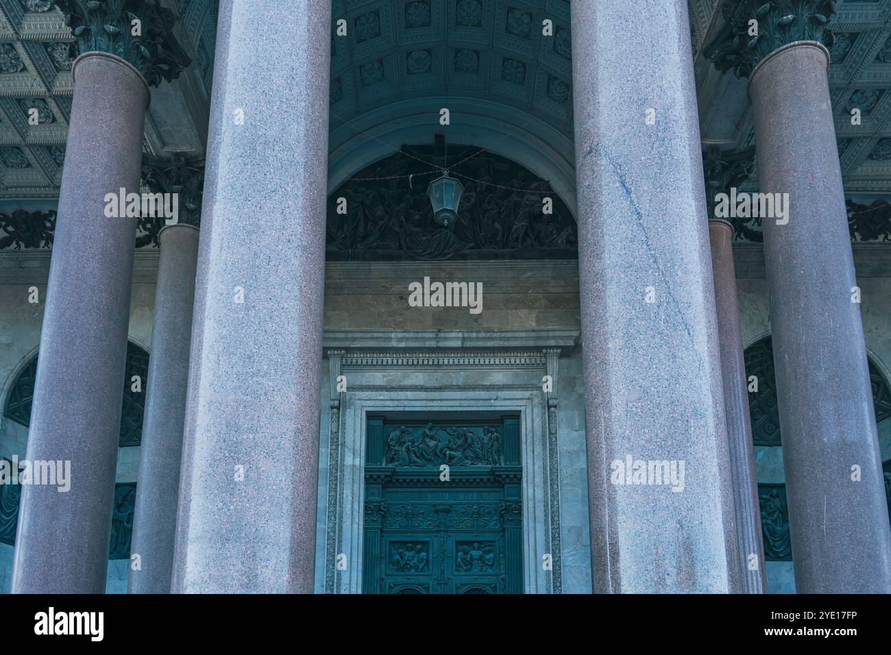 Close-up of a grand entrance featuring towering columns and an ornate ...