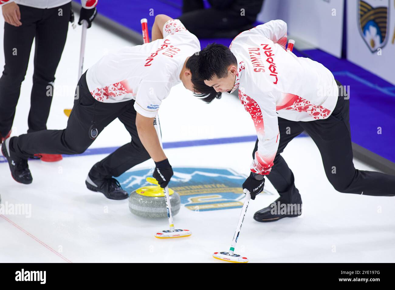 SATO Hayato (L) and SHIMIZU Tetsuro (R) sweep a stone at the 2024 Pan Continental Curling ...