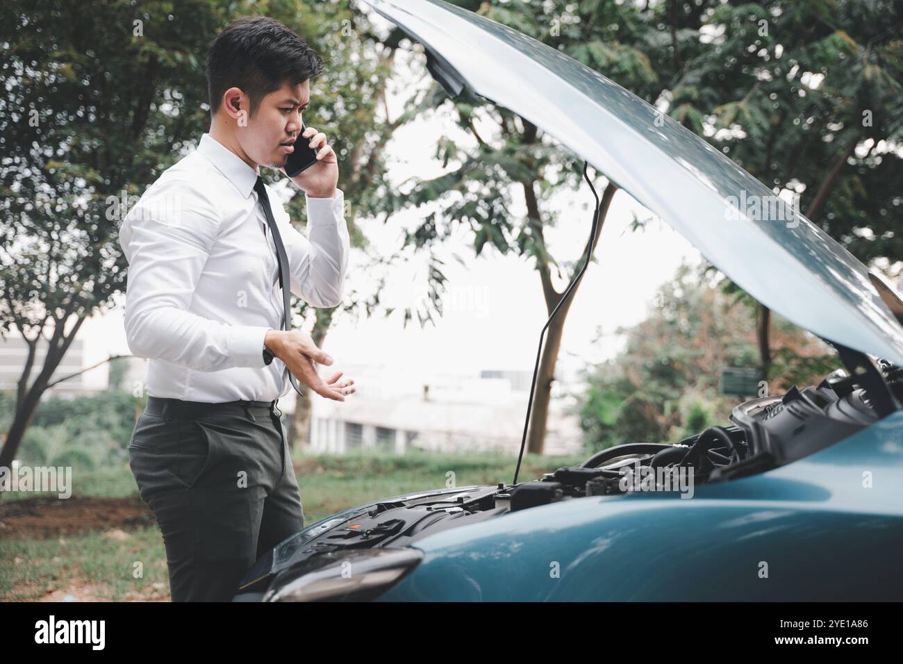 Asian businessman stranded on the road after car breakdown Stock Photo ...