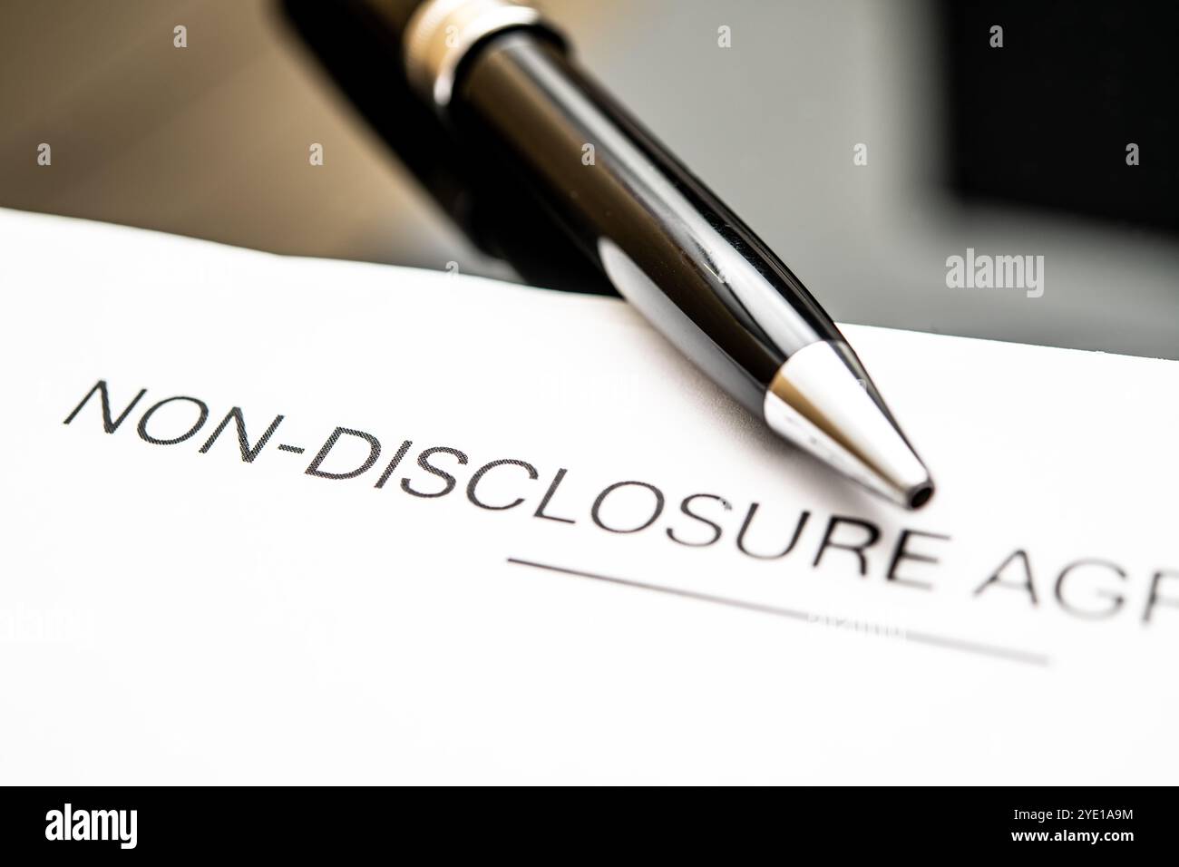 Non-disclosure agreement document with a sleek pen, representing legal ...