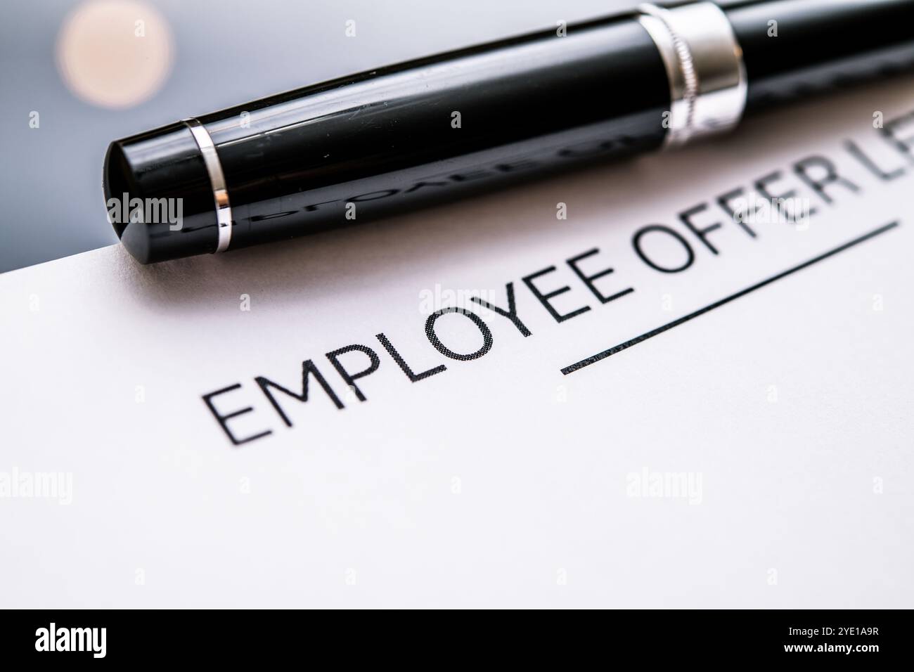 This image showcases a business employee offer letter and a stylish pen ...