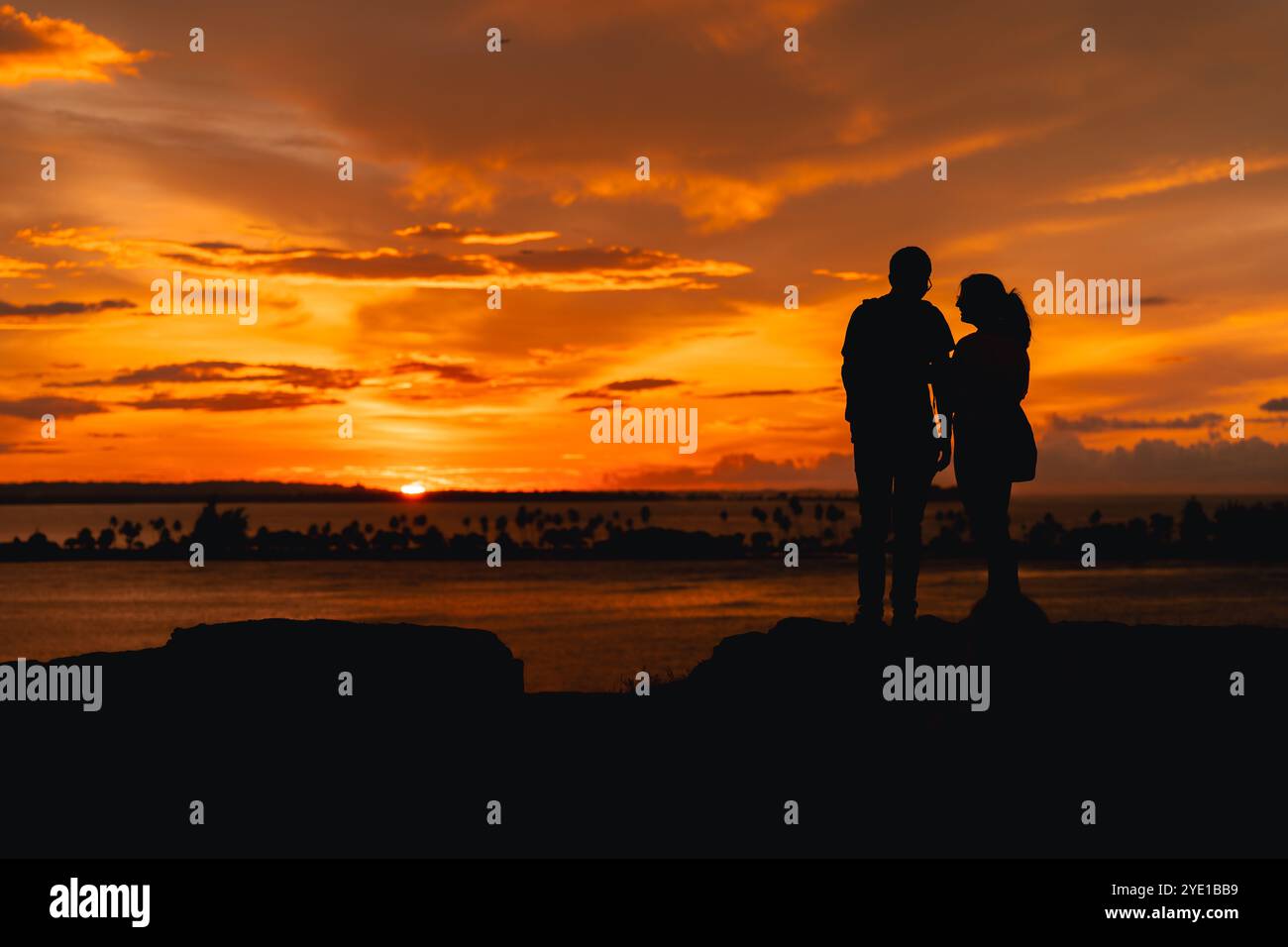 Silhouette Of A Couple Standing By The Water At Sunset Near El Morro ...