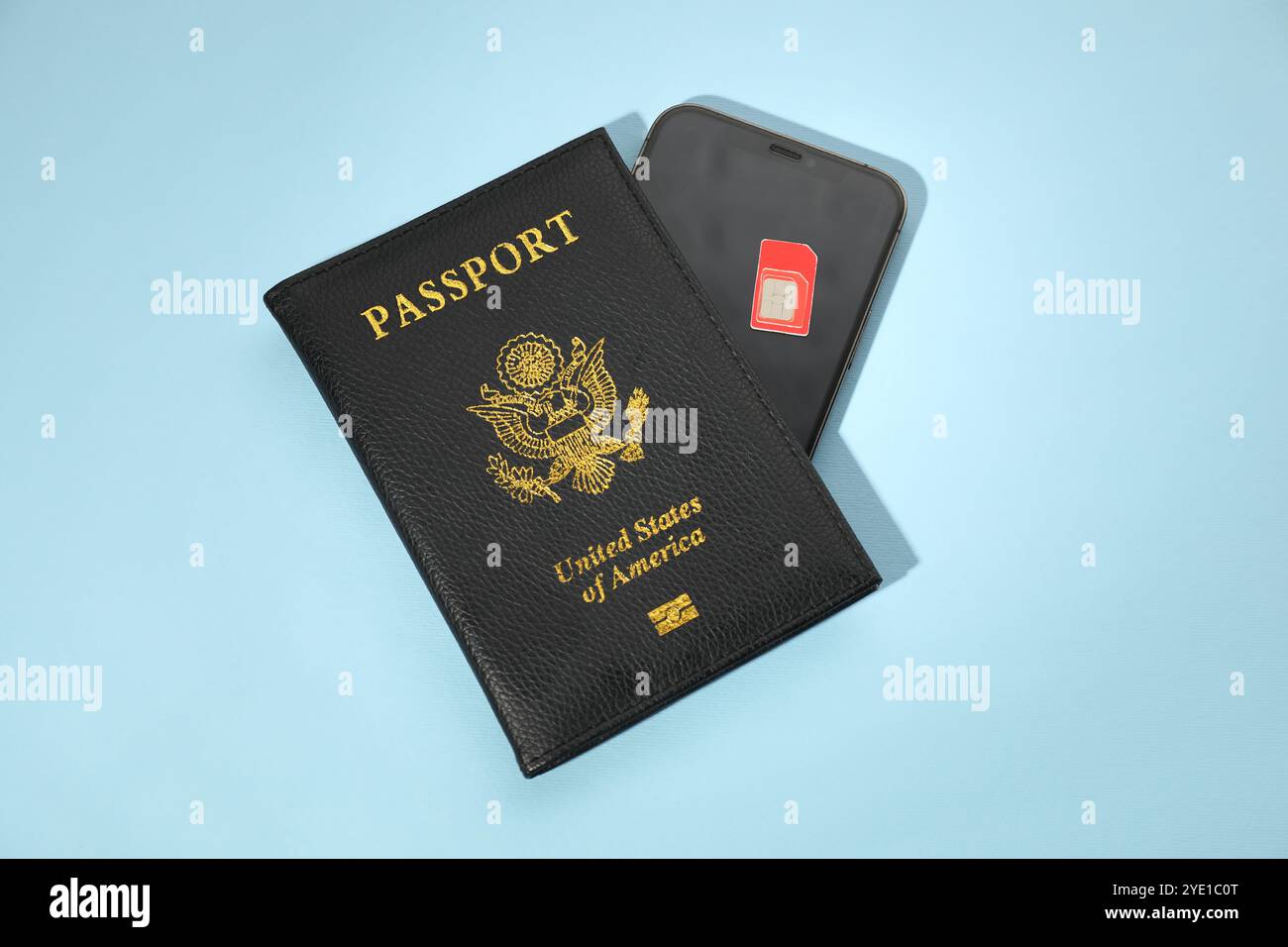Modern SIM card, smartphone and passport on light blue background, top ...