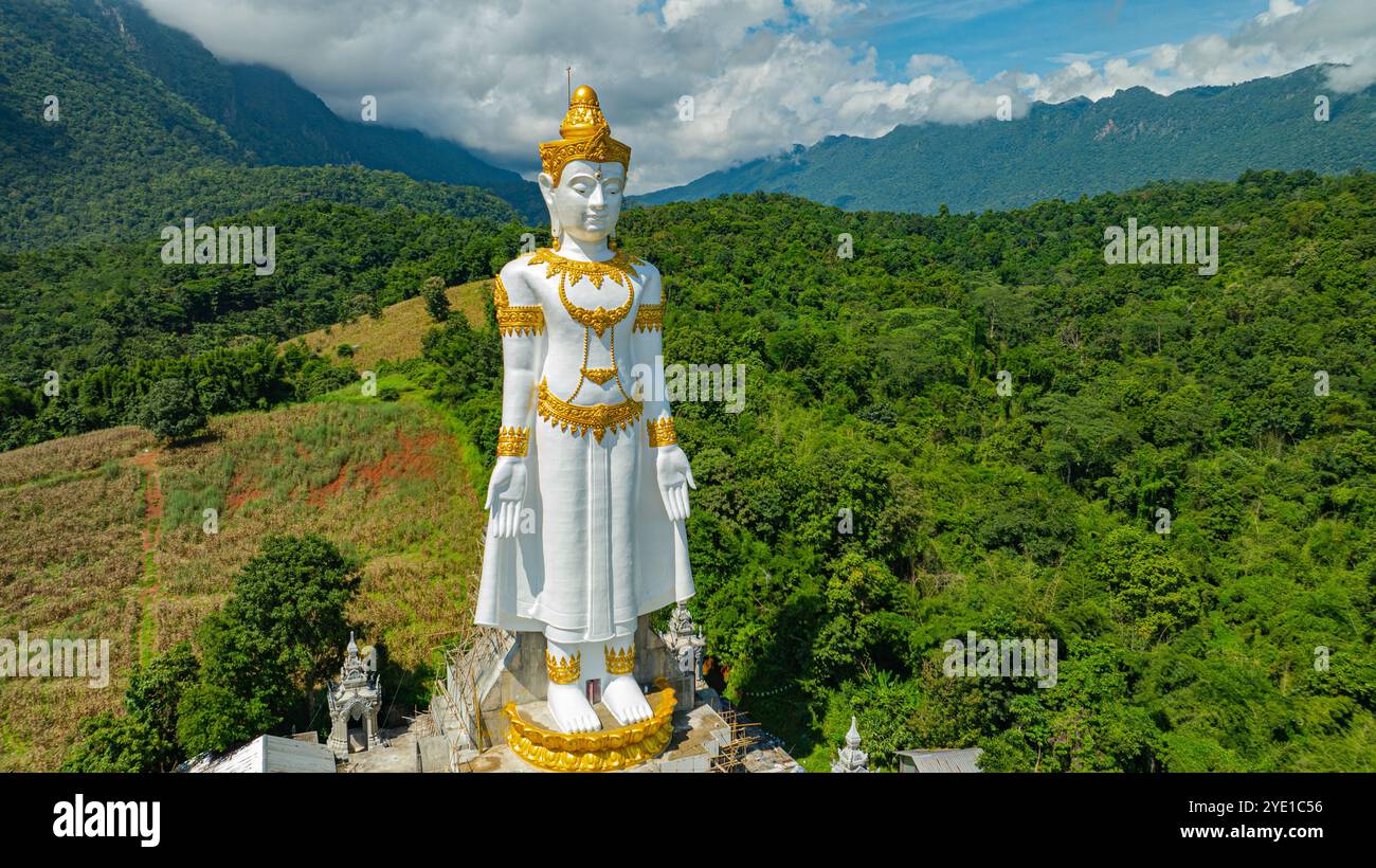 Big Buddha Brahma Panyo standing tall in front of Doi Luang mountain ...
