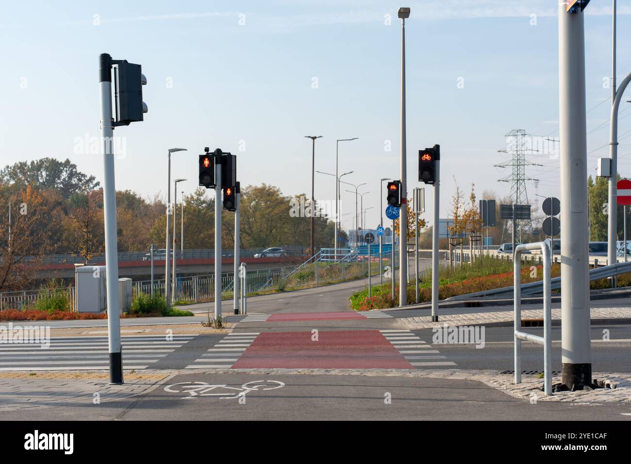 Urban pedestrian and cycle crossing with red cycle lane and traffic ...
