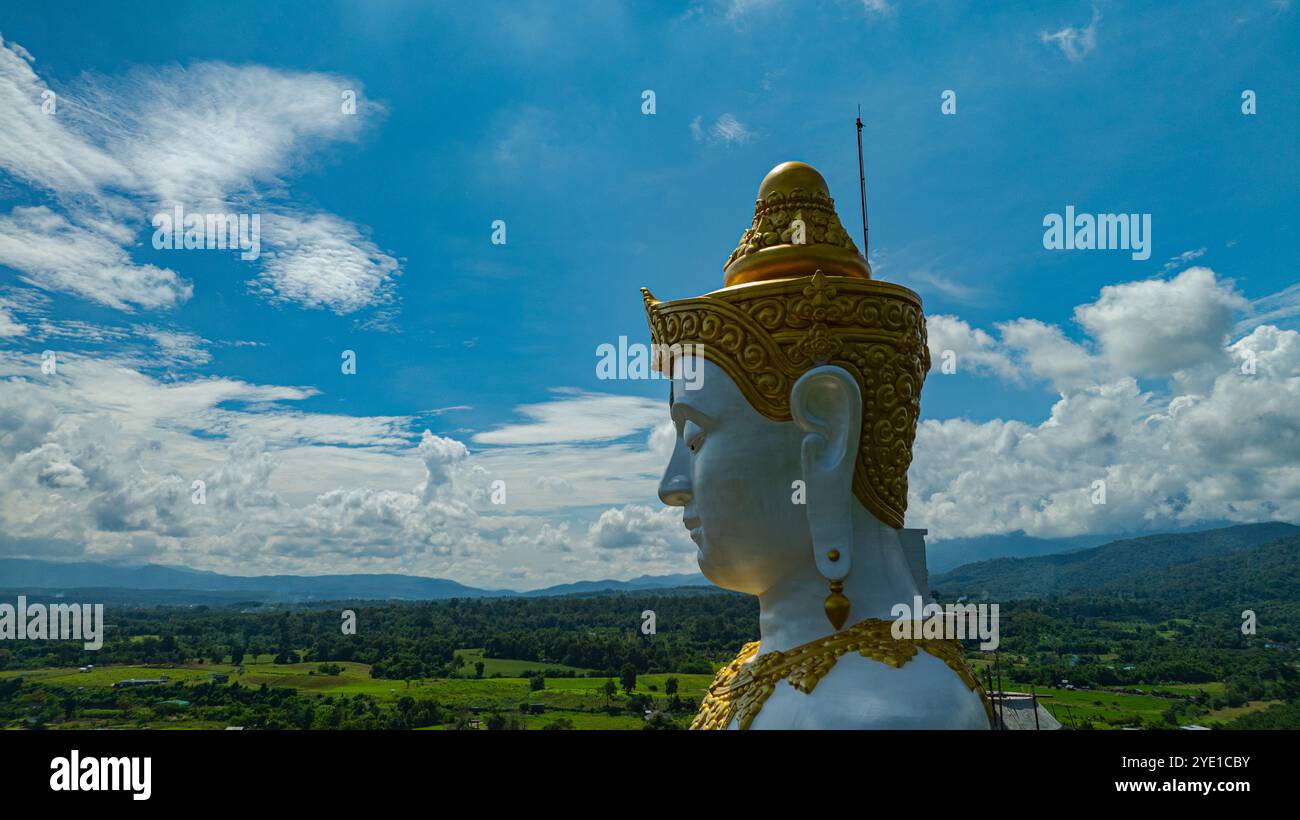 Close up the Tall Buddha Brahma Panyo statue standing tall in front of ...