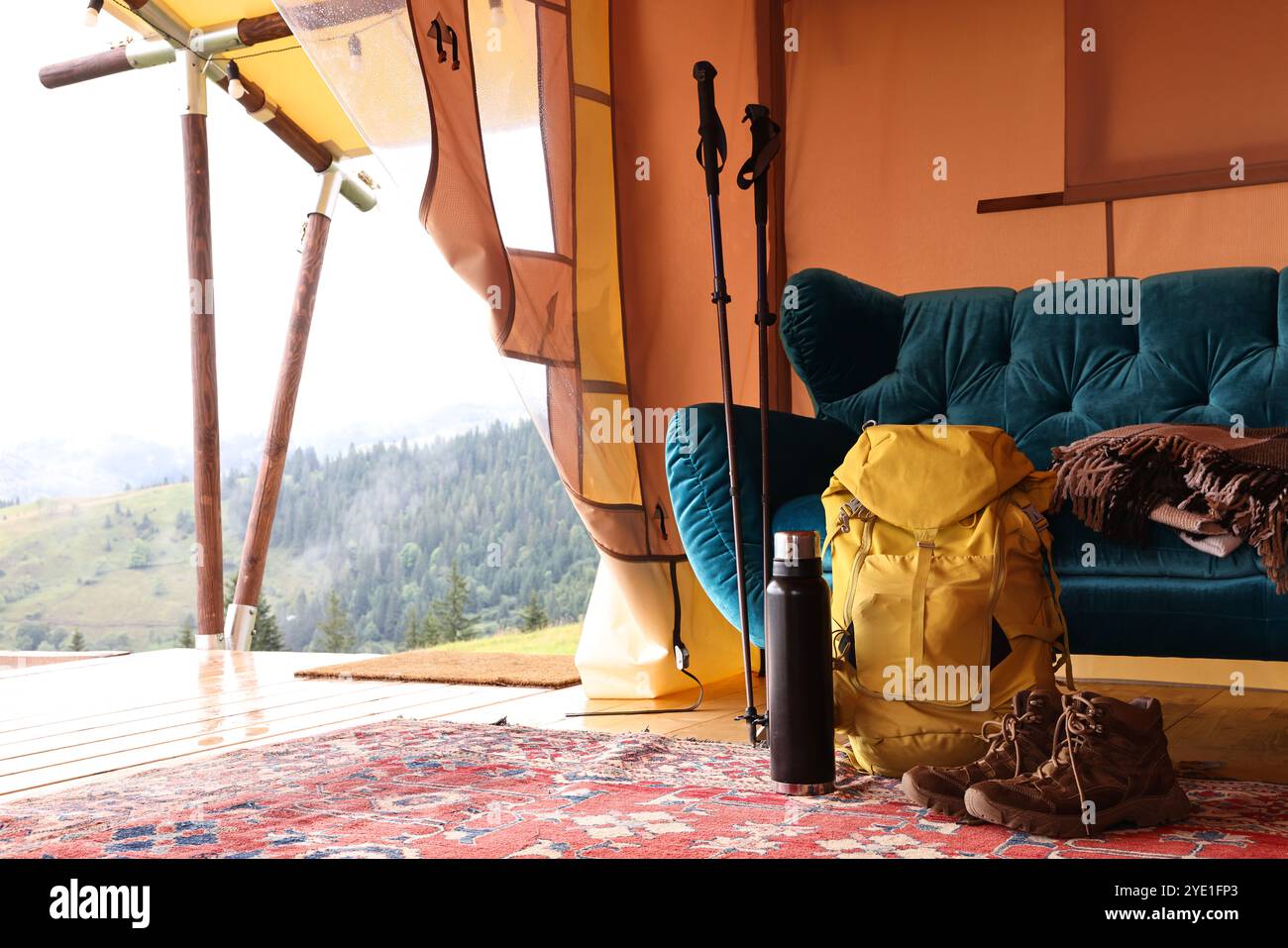 Comfortable sofa and tourist stuff in glamping site Stock Photo - Alamy