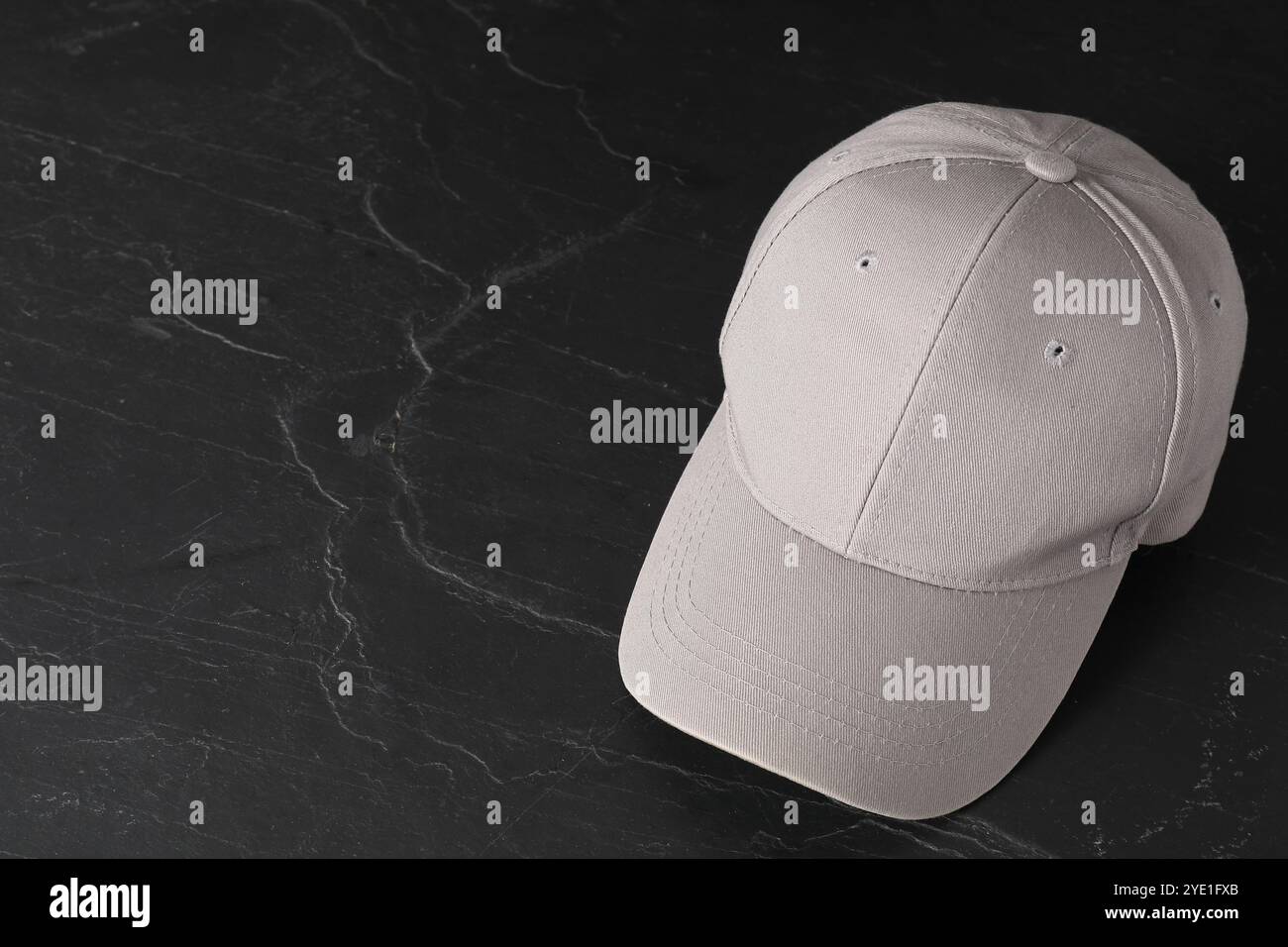 Stylish baseball cap on dark textured table. Mockup for design Stock ...