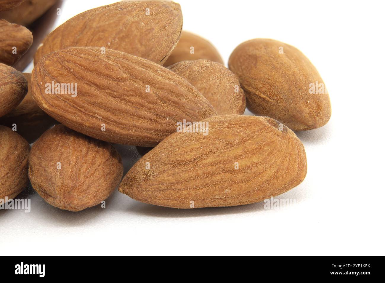 A detailed close-up of raw almonds showcasing their natural texture and ...