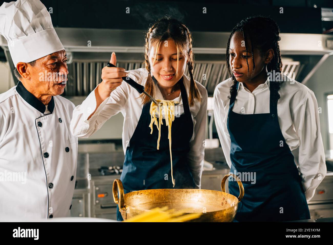 In kitchen chef instructs students. Schoolgirls create ramen. Kids and ...