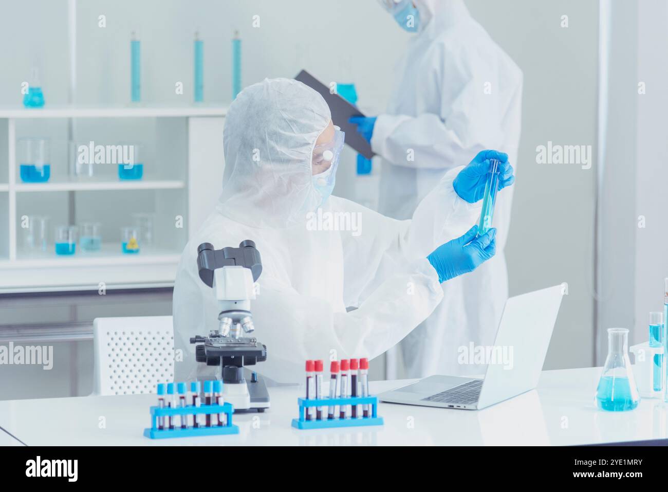 Two asian scientist team reserch chemistry science tube experiment ...