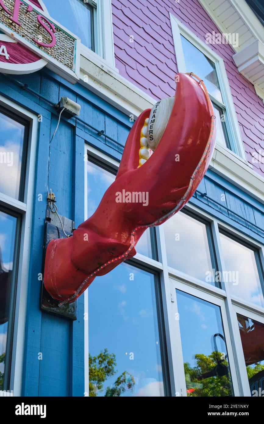 A giant, 3D red lobster claw sign for Giddy's restaurant, mounted to the front of the building ...