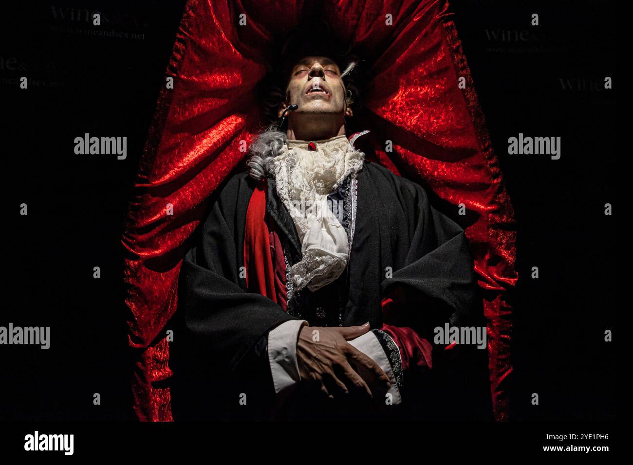 Actor dressed up like Dracula lying on a red velvet coffin Stock Photo ...